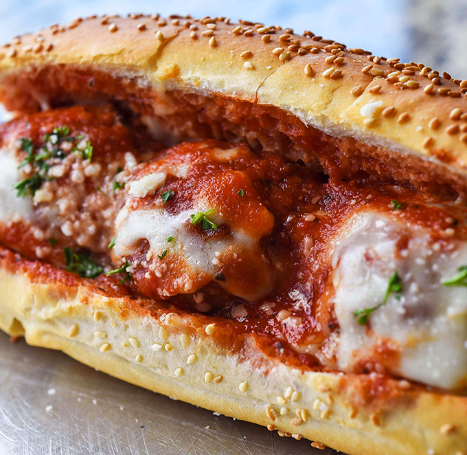 Behold the star of our show: the meatball sub in all its saucy, cheesy glory. This isn't just lunch—it's a religious experience with melted mozzarella.
