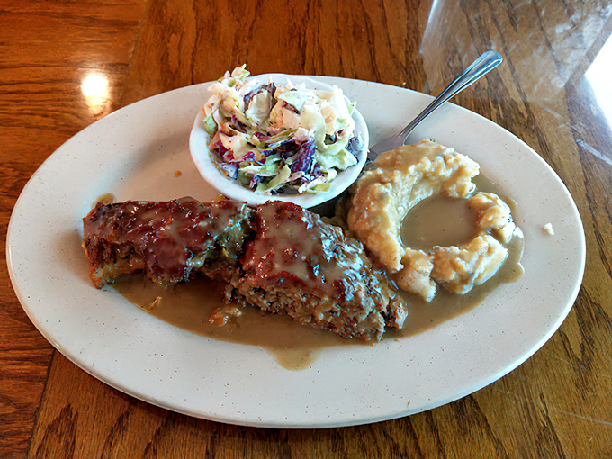 Behold the star attraction: Leo's meatloaf swimming in rich gravy alongside creamy coleslaw and mac and cheese. Grandma would approve—and be jealous.