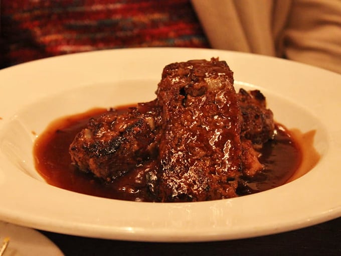 Behold the star attraction – meatloaf that's been elevated from humble weeknight dinner to culinary masterpiece, swimming in savory gravy.