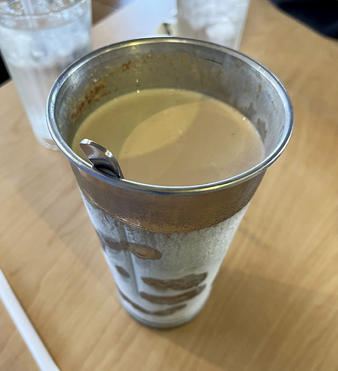 This isn't just a milkshake—it's a frosty time machine to when desserts were honest and straightforward. The metal mixing cup is the bonus round nobody asked for but everyone appreciates.