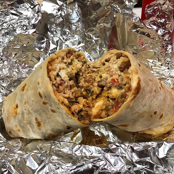 Behold the cross-section of burrito perfection – where rice, beans, meat, and cheese achieve a harmony that would make a symphony conductor weep.