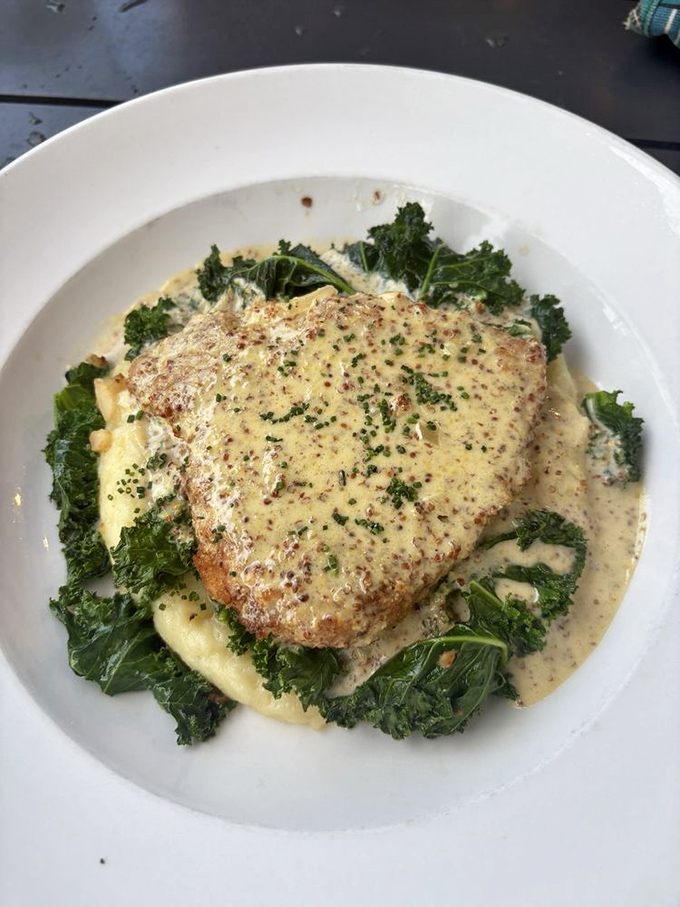 This isn't just chicken—it's a masterclass in comfort, nestled on a bed of greens and bathed in a sauce that whispers, "Cancel your afternoon plans."