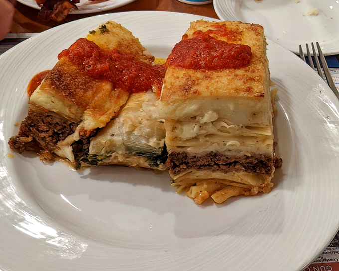 This isn't just pasta—it's a layered masterpiece of comfort. The moussaka arrives steaming hot with a golden top that gives way to savory treasures below.