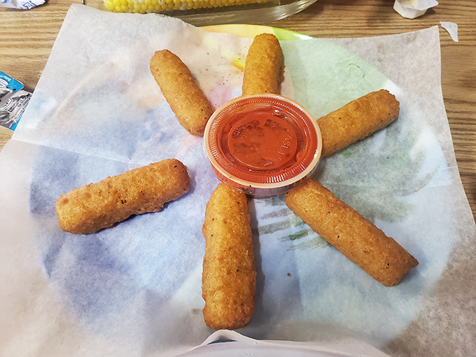 Golden-brown mozzarella sticks arranged like a sunburst around marinara. Simple pleasures done right—crispy exterior, molten cheese interior.