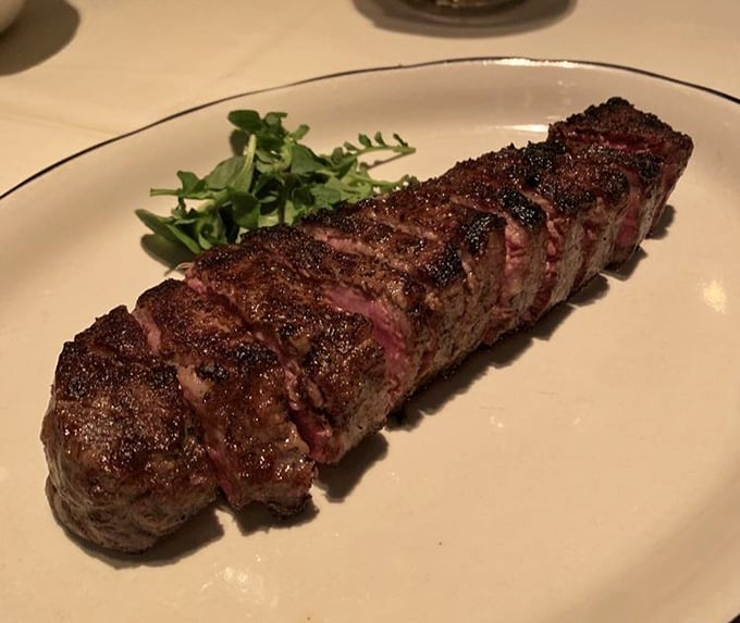 The New York Strip arrives like a masterpiece—perfectly charred exterior giving way to a rosy interior. This isn't just steak; it's edible poetry.