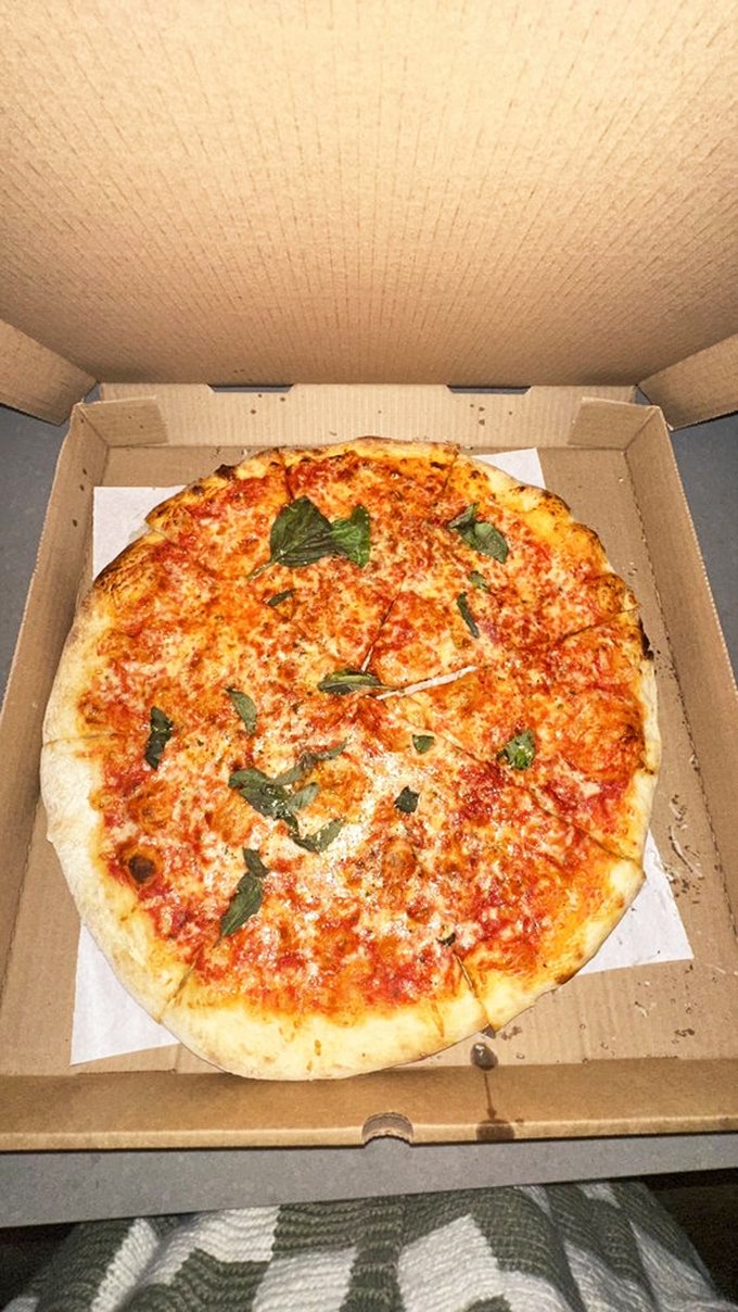 The classic margherita with fresh basil—pizza in its purest form. That crust has the perfect char that whispers, "I was made by someone who cares." 