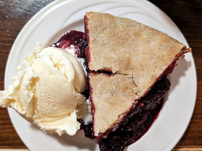 The legendary olallieberry pie arrives with a scoop of vanilla ice cream slowly surrendering to the warm, purple filling. This is what berry dreams are made of.