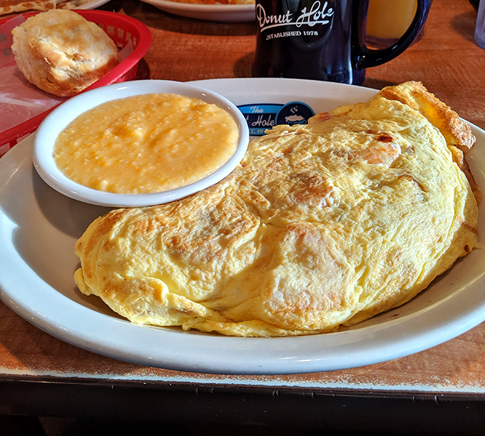 Behold, the omelet in its natural habitat—perfectly folded, gloriously golden, and ready to make your morning memorable. Grits on standby.