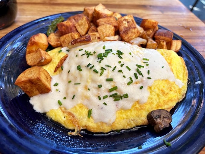 This isn't just any omelet—it's a fluffy golden pillow topped with a silky sauce that makes those home-cooked attempts seem like sad, deflated cousins.