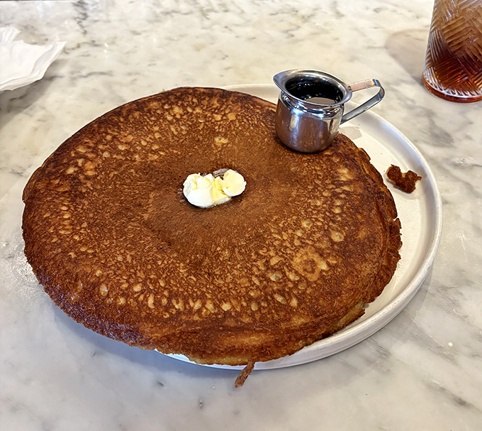 Behold the pancake in its natural habitat—golden-brown perfection that's practically auditioning for the breakfast hall of fame.