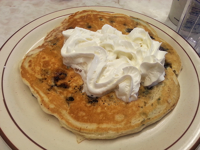 This blueberry pancake with whipped cream isn't trying to be Instagram-famous—it's too busy being absolutely delicious.