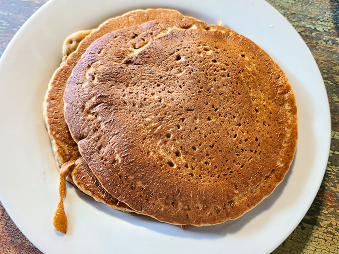 These golden-brown pancakes aren't just breakfast, they're therapy—perfectly porous to soak up syrup while maintaining their structural integrity. Engineering meets comfort food.