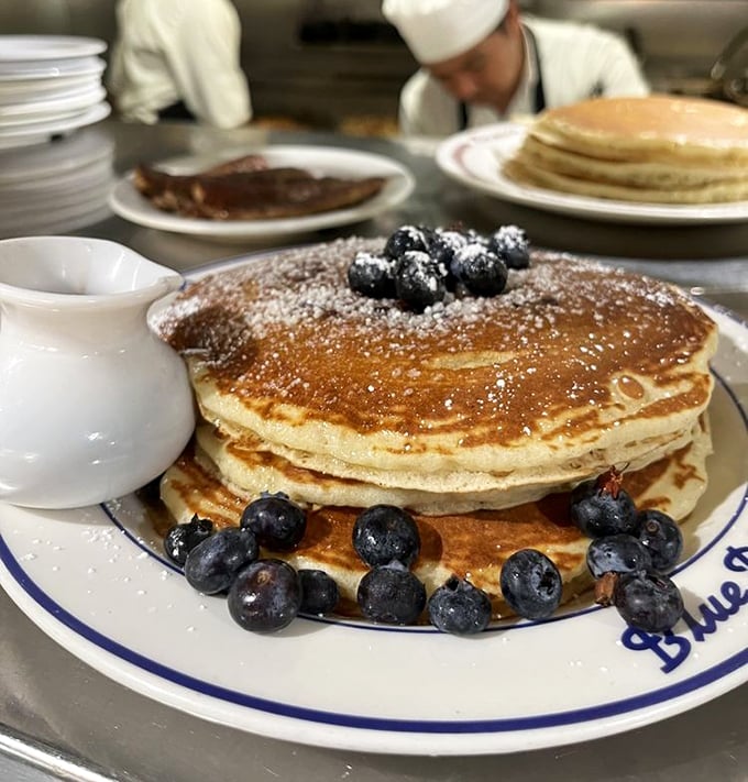 Pancake perfection isn't just about height—it's about that golden exterior giving way to cloud-like interior. These blueberry-studded beauties are breakfast nirvana.