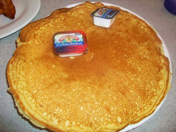 Behold the famous pancake in all its golden glory! Two butter pats look like tiny islands on this magnificent disc of breakfast perfection.