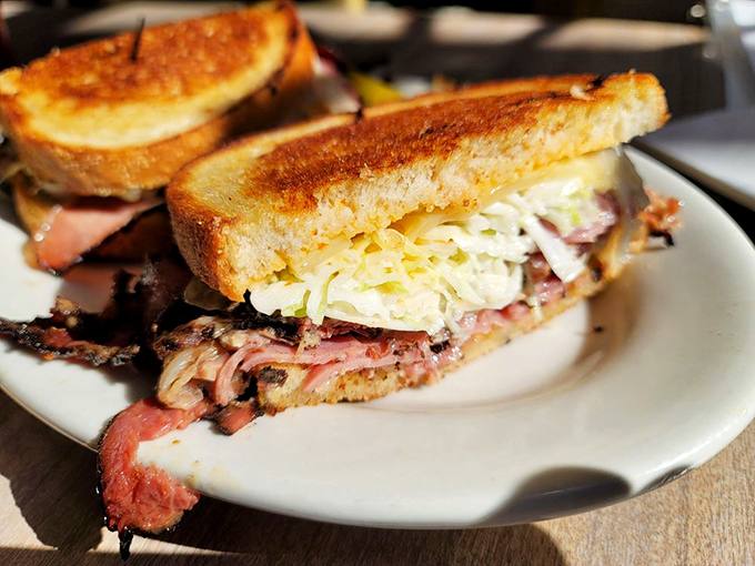 Behold the sandwich that launches a thousand road trips—perfectly grilled bread embracing a mountain of meat with just enough slaw for that essential crunch.