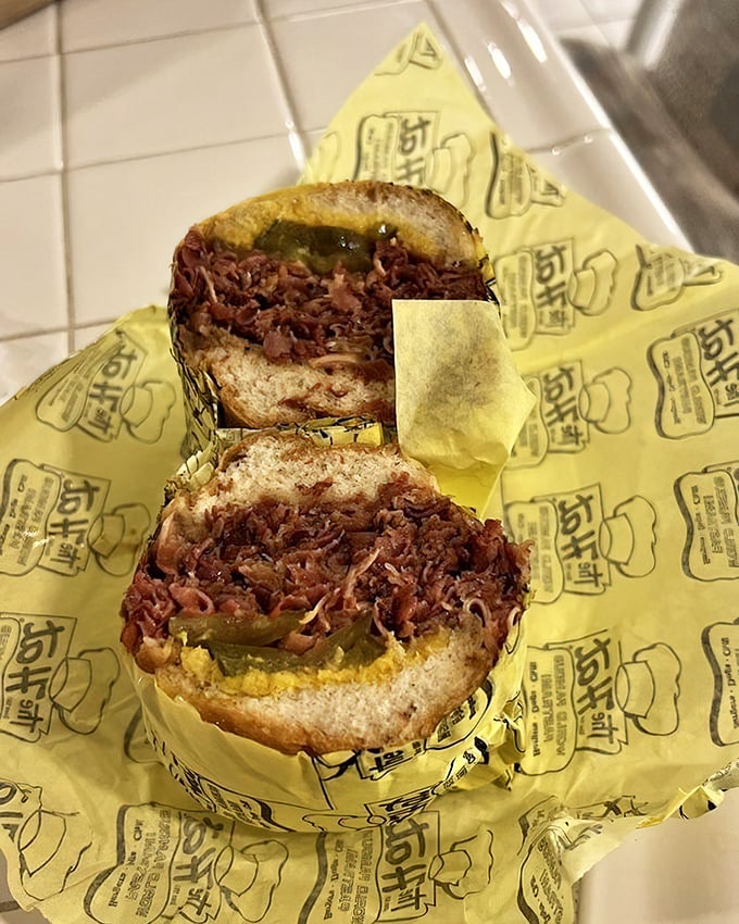 Behold the star of the show—layers of thinly-sliced pastrami piled so high you'll need to unhinge your jaw like a python.