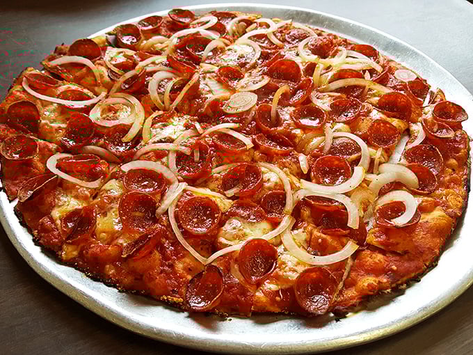 Pepperoni that curls into little cups of savory perfection, thin crust that defies physics, and onions sliced so thin they practically melt—this is pizza poetry.