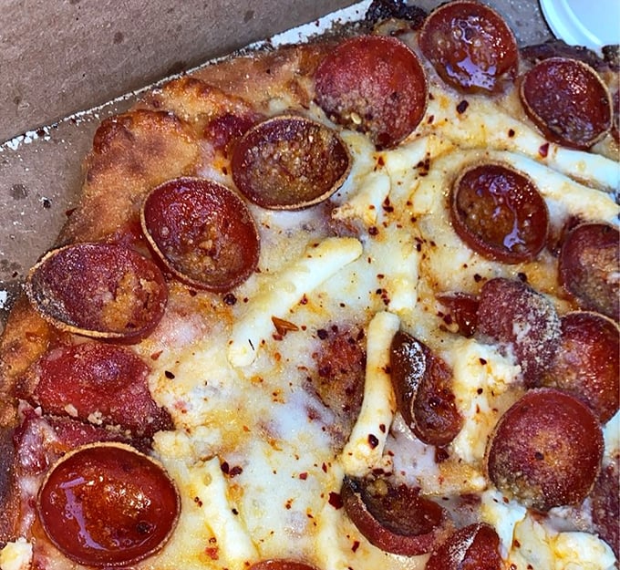 Cup-and-char pepperoni that curls into little flavor pools—nature's way of saying "I love you" in pizza language.