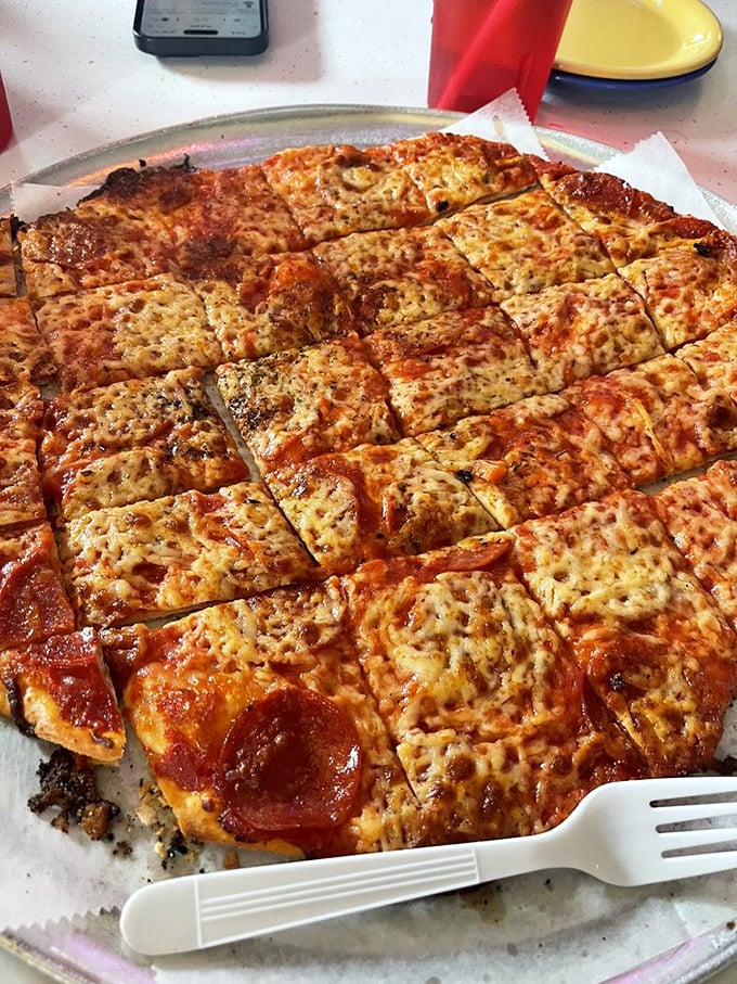 The square-cut pepperoni pizza isn't just food—it's edible geometry where each crispy corner piece becomes a treasured prize.