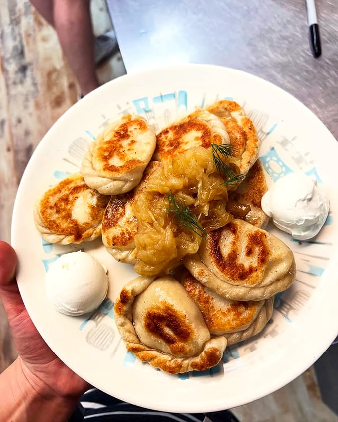 Golden-brown pockets of joy, these pan-fried pierogies with caramelized onions and sour cream are what dreams—and stretchy pants—were made for.