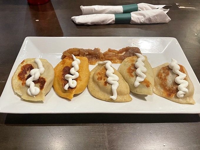 Golden-brown pierogi perfection! These plump dumplings with their zigzag of sour cream are what food dreams are made of—crispy edges, tender centers, pure joy.