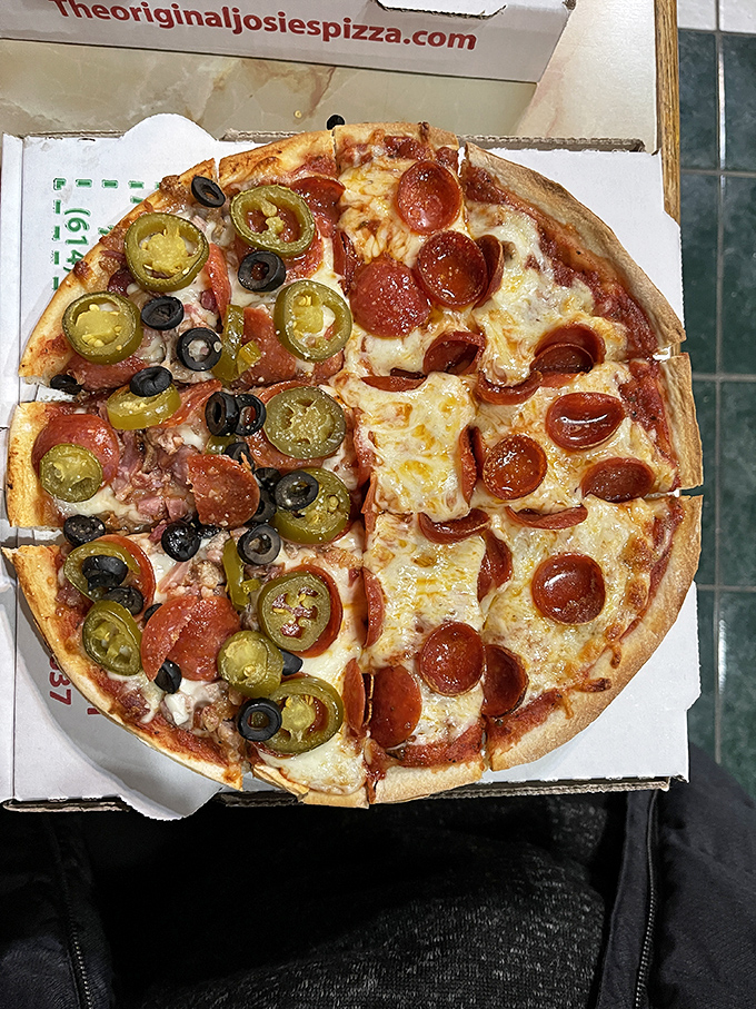 Pizza perfection in its natural habitat—those curled-up pepperoni cups creating little pools of flavor that make resistance absolutely futile.