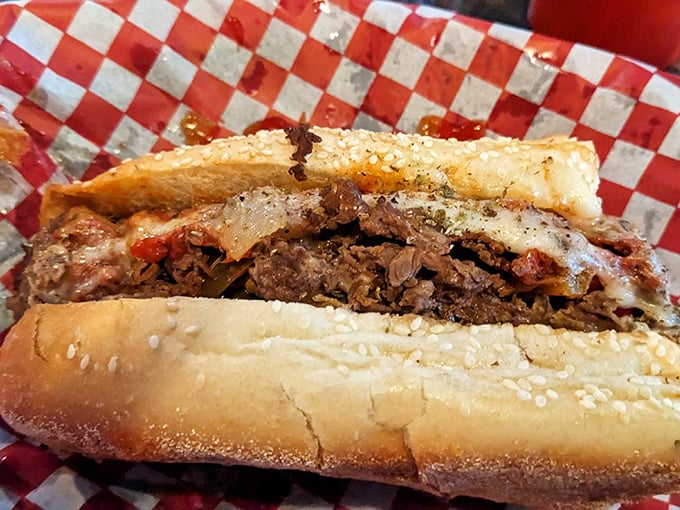 The legendary pizza steak in all its glory – where thinly sliced beef meets melty cheese and tangy sauce in a harmony that makes taste buds stand at attention.