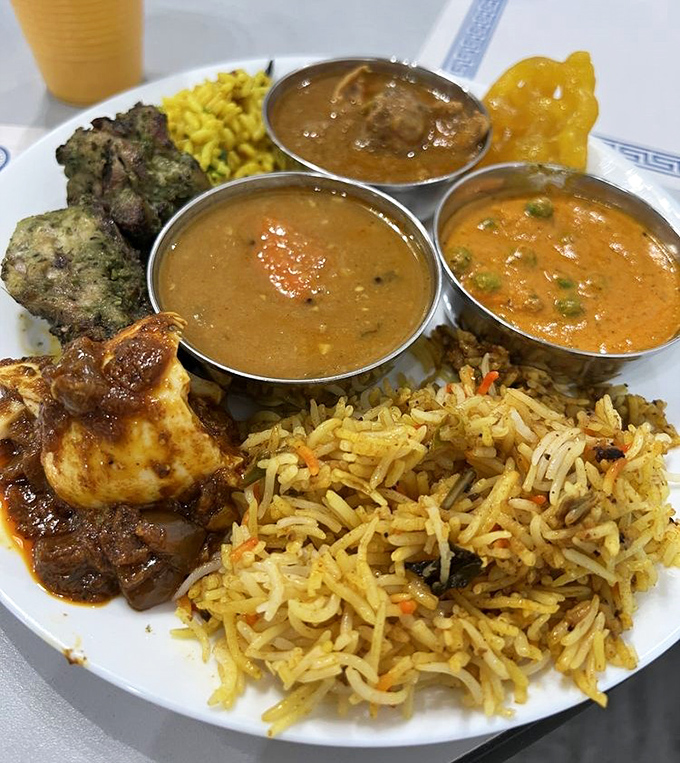 A plate that tells the story of India in one glance – fragrant biryani, vibrant curries, and that perfectly charred chicken calling your name.
