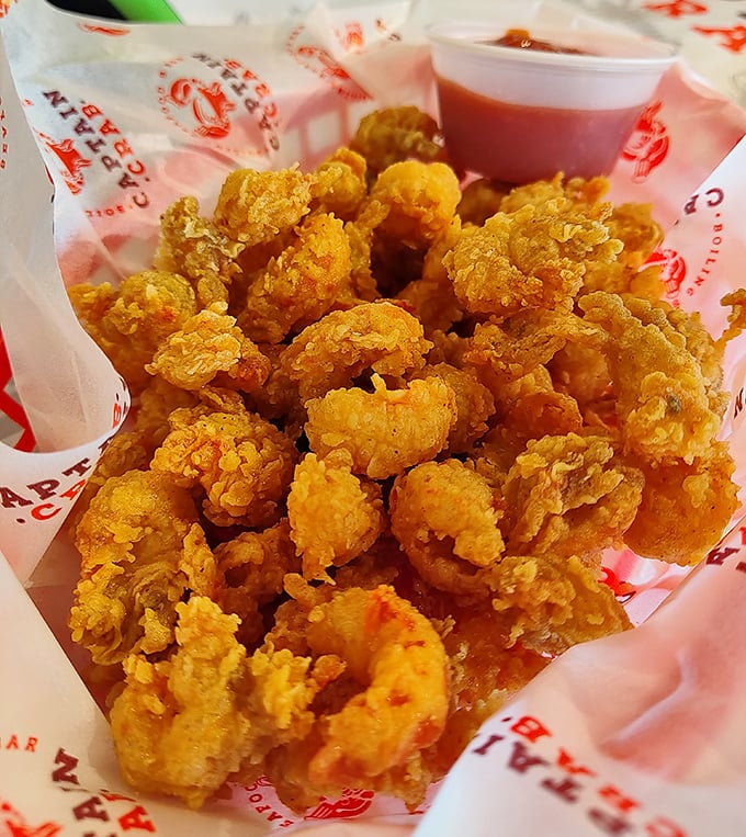 The legendary popcorn crawfish—crispy, golden nuggets of joy that disappear faster than good intentions on vacation. Worth every finger-licking moment.