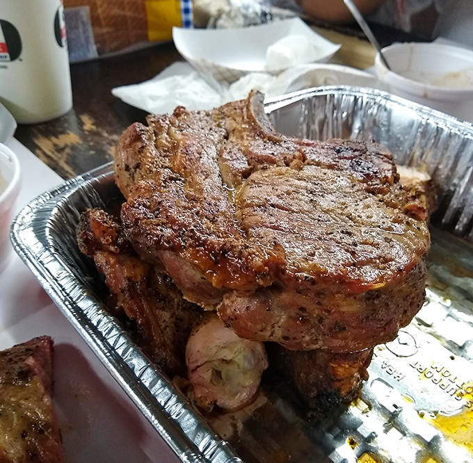 The legendary pork chop in all its glory—two inches thick with a perfect crust that makes vegetarians question their life choices.