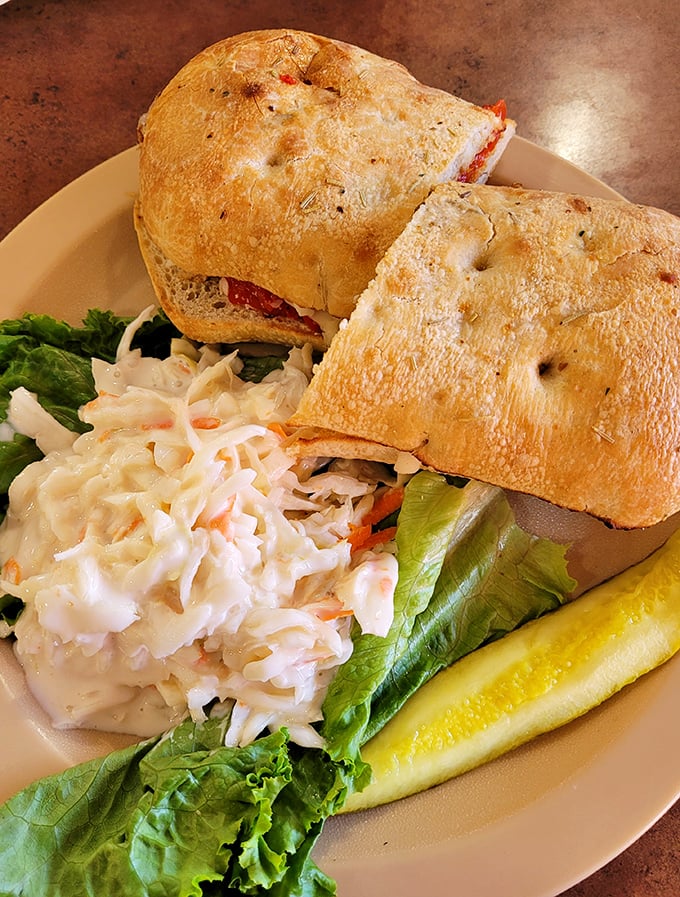 Not all heroes wear capes—some come on fresh bread with coleslaw and a pickle. This sandwich doesn't need Instagram filters to look this good.