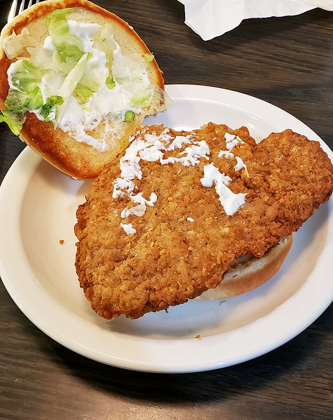 This isn't just a sandwich—it's a golden-fried monument to the Midwest, where pork tenderloin refuses to be contained by mere bread.