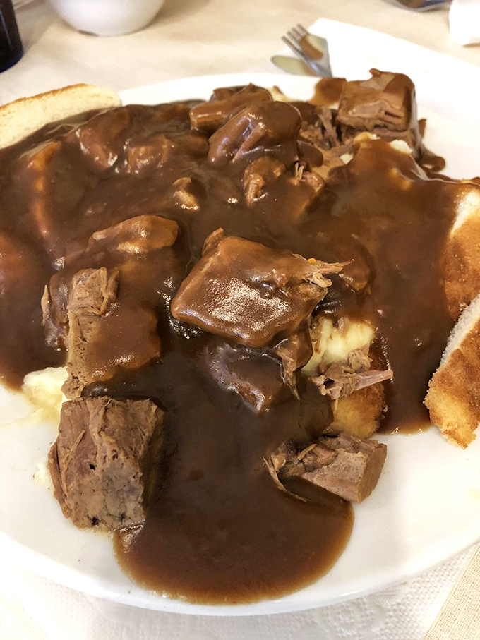Behold the pot roast in its natural habitat: swimming in gravy thick enough to write home about.