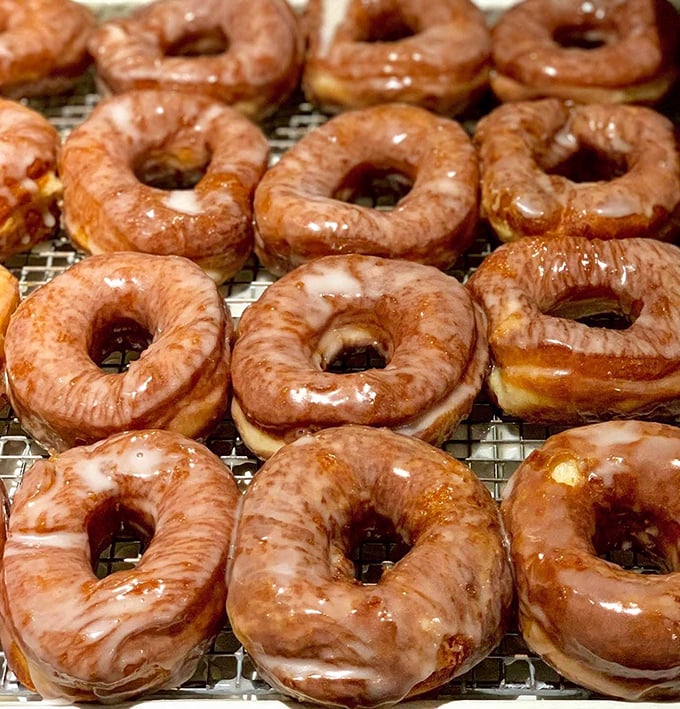 Glazed potato donuts glisten with sweet promise. These aren't your average hole foods—they're the reason alarm clocks were invented.