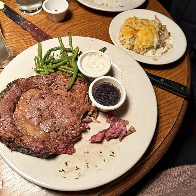 Behold the prime rib—a carnivore's sonnet with a side of green beans and two dipping sauces that deserve their own fan clubs.