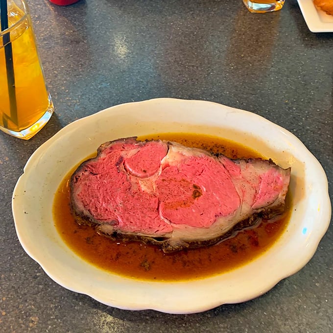 Prime rib perfection – a rosy center surrounded by a seasoned crust, swimming in au jus that could make a vegetarian question their life choices.