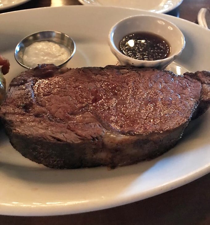 This prime rib isn't just cooked—it's been on a spiritual journey. The accompanying au jus and horseradish are merely there to witness its glory.