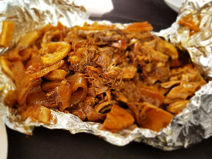 Glistening carnitas in all their glory. This isn't just pulled pork—it's a masterclass in patience, rendered fat, and culinary alchemy.