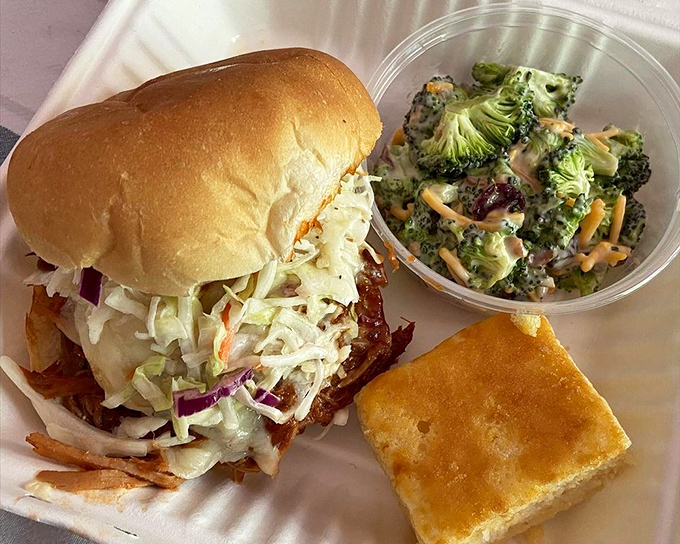 The star of the show: Hood's pulled pork sandwich with coleslaw that doesn't know the meaning of "subtle." That cornbread square isn't a side—it's an essential supporting character.