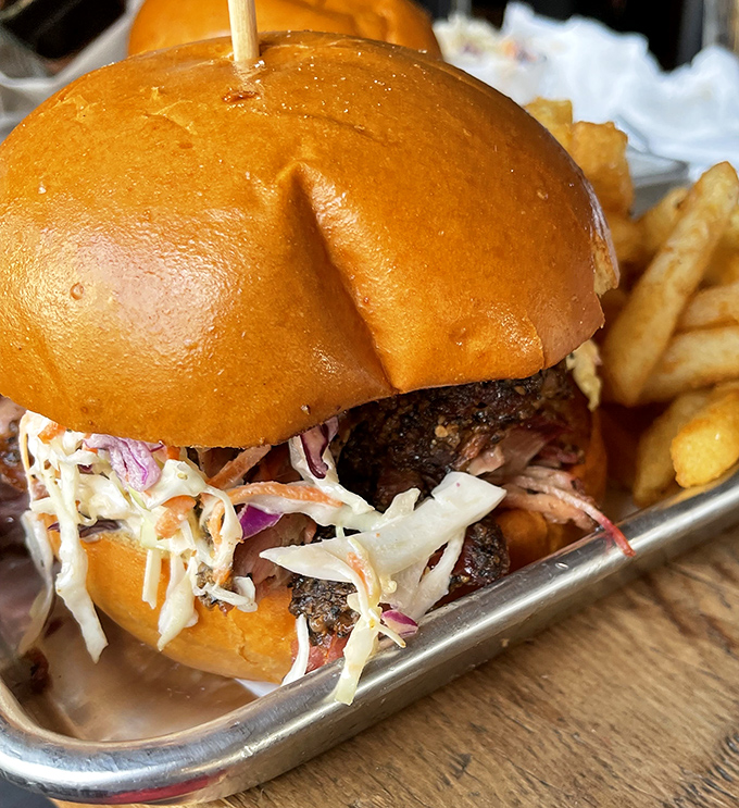 Not all heroes wear capes; some come on brioche buns. This pulled pork sandwich with slaw is what dreams are made of.