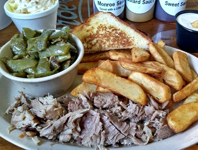 Behold the holy trinity of Southern comfort: tender pulled pork, green beans swimming with flavor, and fries that could make a Frenchman weep.