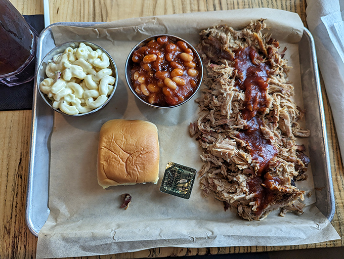 Pulled pork that looks like it's been gently coaxed apart rather than pulled, alongside mac and cheese that's practically begging for your attention.