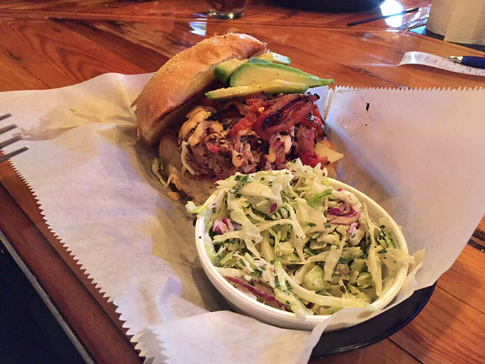 The pulled pork sandwich doesn't just sit on the plate—it commands it, with avocado adding a California twist to this Southern classic.