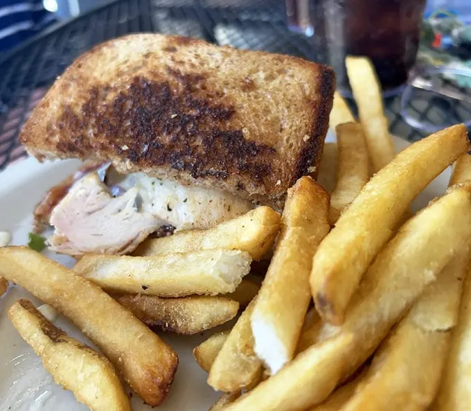 This sandwich isn't just lunch—it's therapy between bread. Golden fries standing at attention like they know they're part of something special.