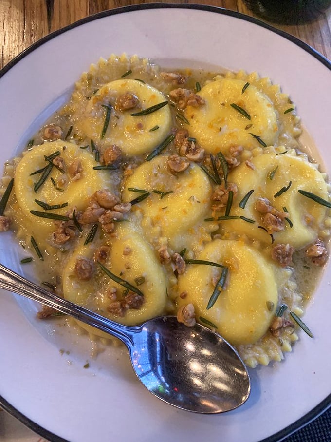 Golden pillows of pasta perfection. These ravioli aren't just served – they're presented like the culinary treasures they are.