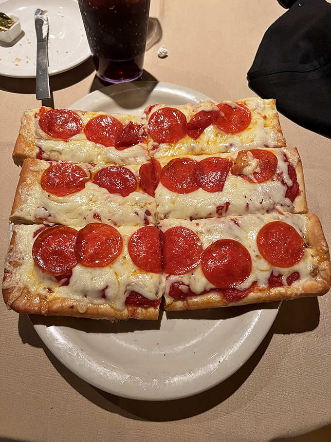 Old Forge pizza isn't just rectangular—it's a geometry lesson in perfect proportions: thick-yet-light crust supporting that distinctive cheese blend and pepperoni that curls into flavor cups.