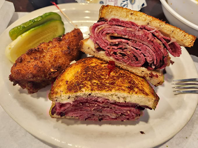 Behold the Reuben in all its glory—layers of corned beef, sauerkraut, and melted Swiss creating what can only be described as a sandwich symphony.