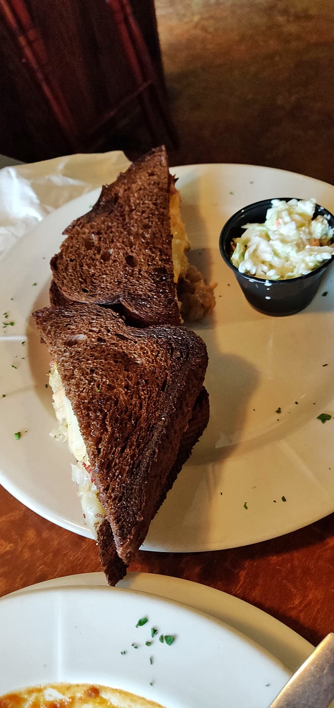 The legendary Reuben in all its glory – perfectly grilled rye bread embracing a mountain of corned beef, sauerkraut, and melted Swiss.