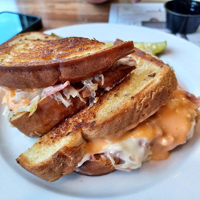 Behold the legendary Reuben in all its glory—grilled rye, melty Swiss, and that perfect ratio of corned beef to sauerkraut that makes time stand still.