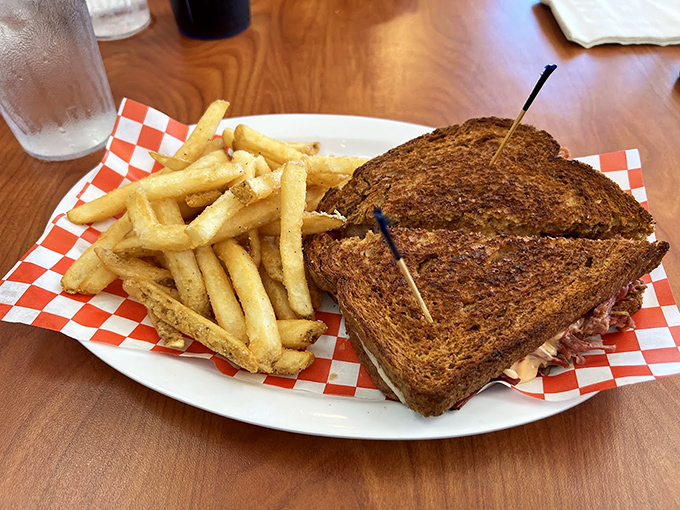 The legendary Reuben arrives like a sandwich superhero—perfectly grilled rye bread, homemade corned beef, and just the right ratio of sauerkraut to Russian dressing. Kryptonite for diets everywhere.
